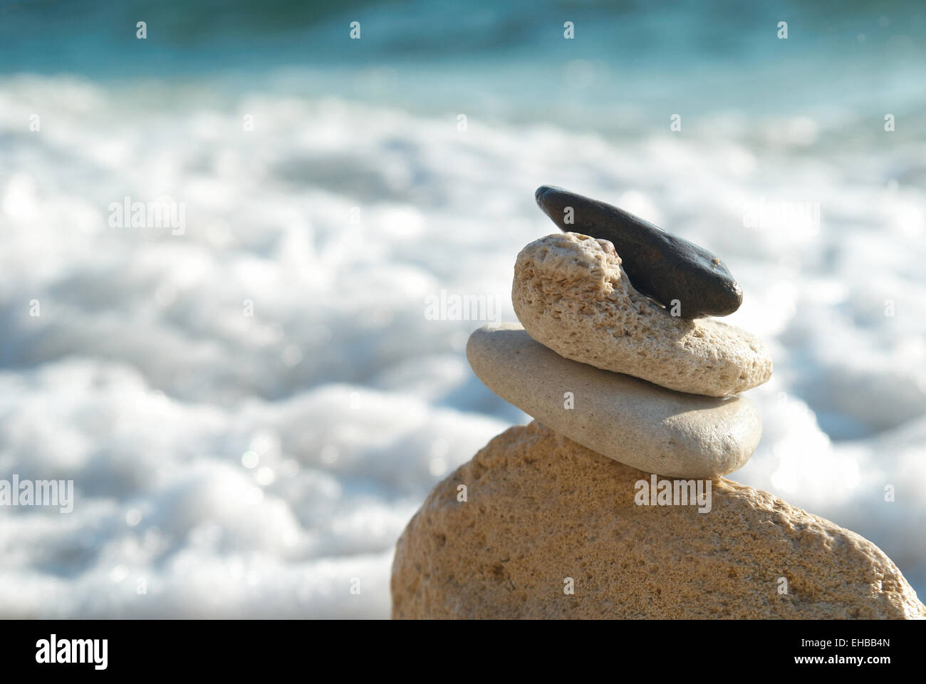 Zen stones with blue sky and sea background Stock Photo - Alamy