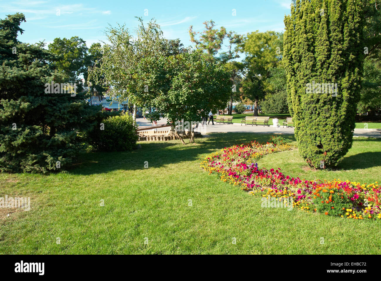 Green sunny park with flowers and trees Stock Photo - Alamy