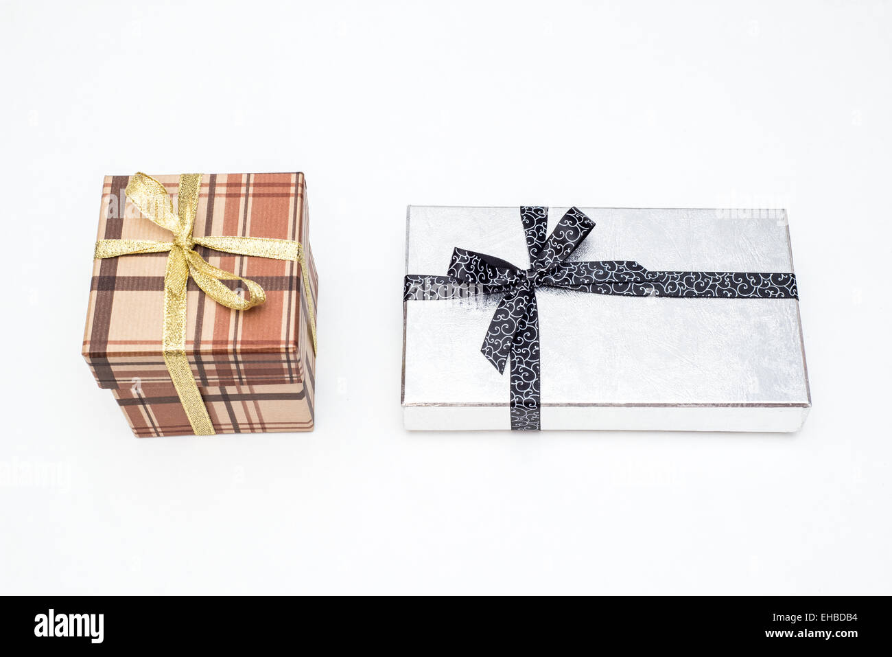 brown and silver gift box with bow on white background Stock Photo - Alamy