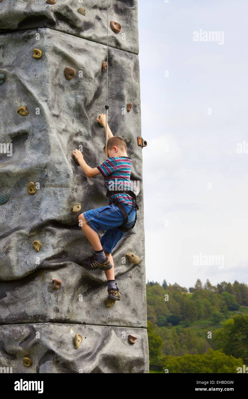 Boy climbing climbing wall Stock Photo - Alamy