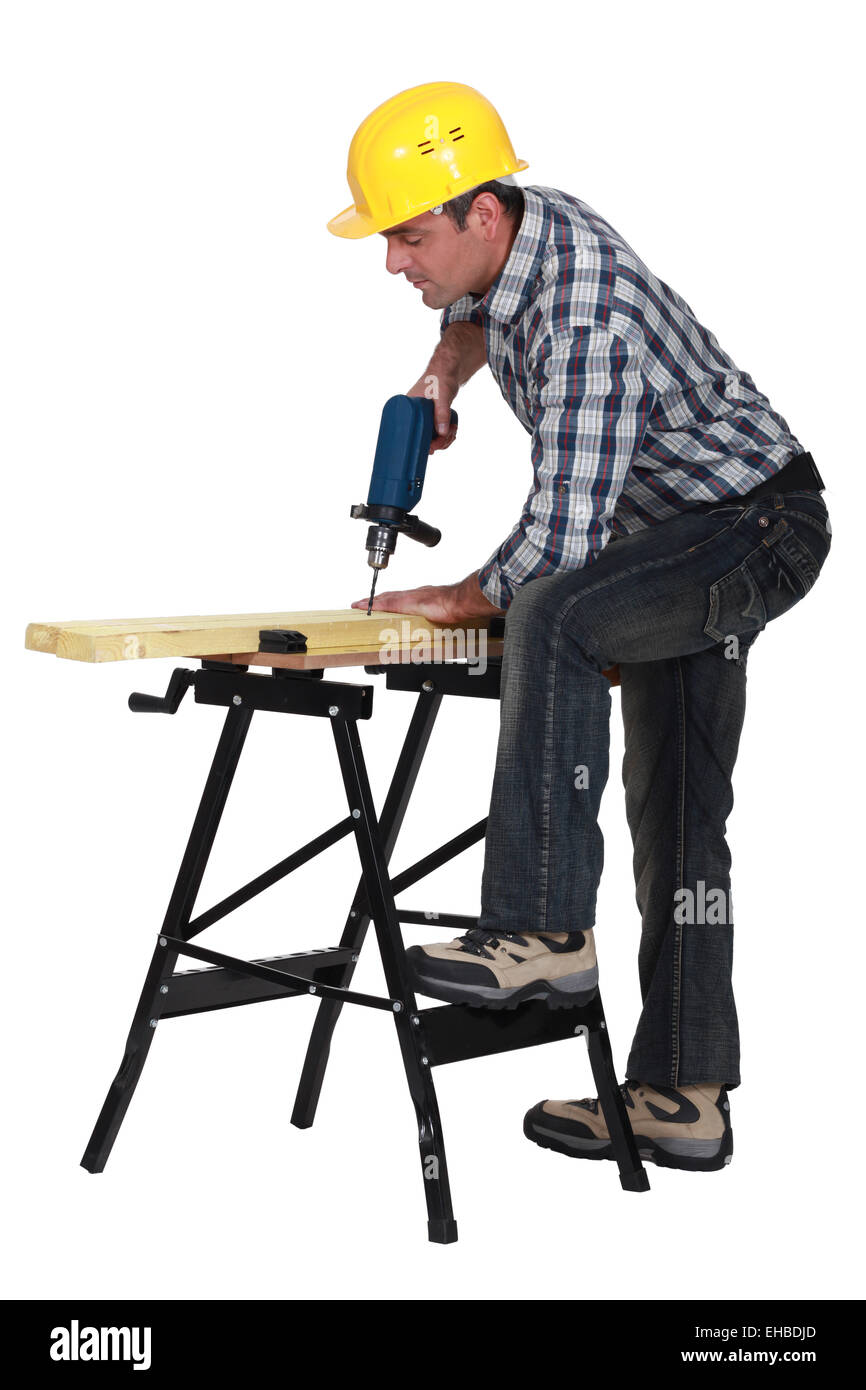 Tradesman using a power tool Stock Photo - Alamy