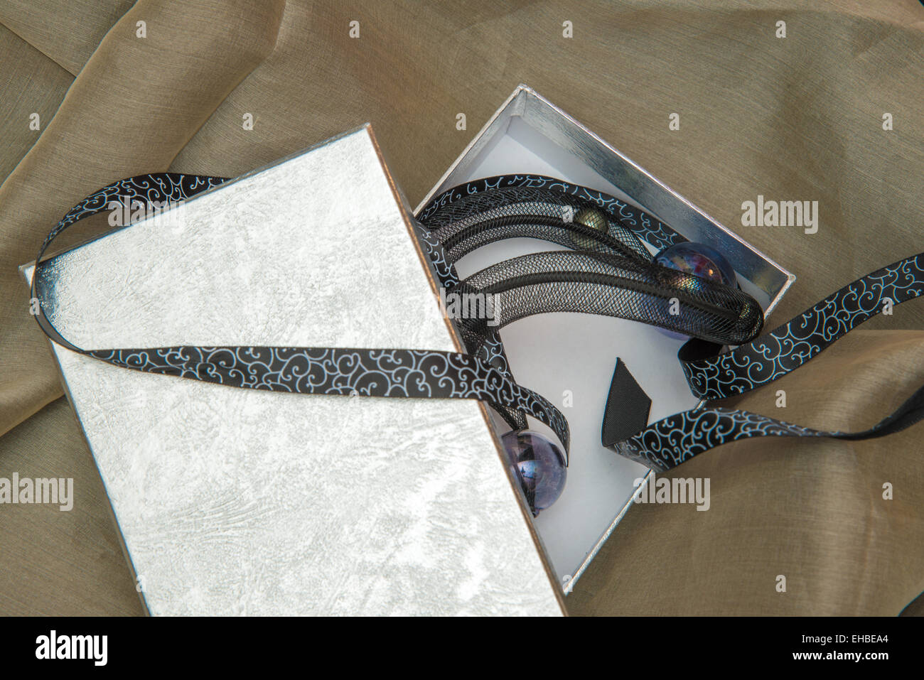 the surprise gift box on the fabric Stock Photo - Alamy