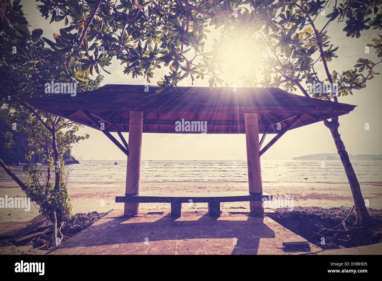 Retro filtered photo of a seaside bench at sunset Stock Photo - Alamy