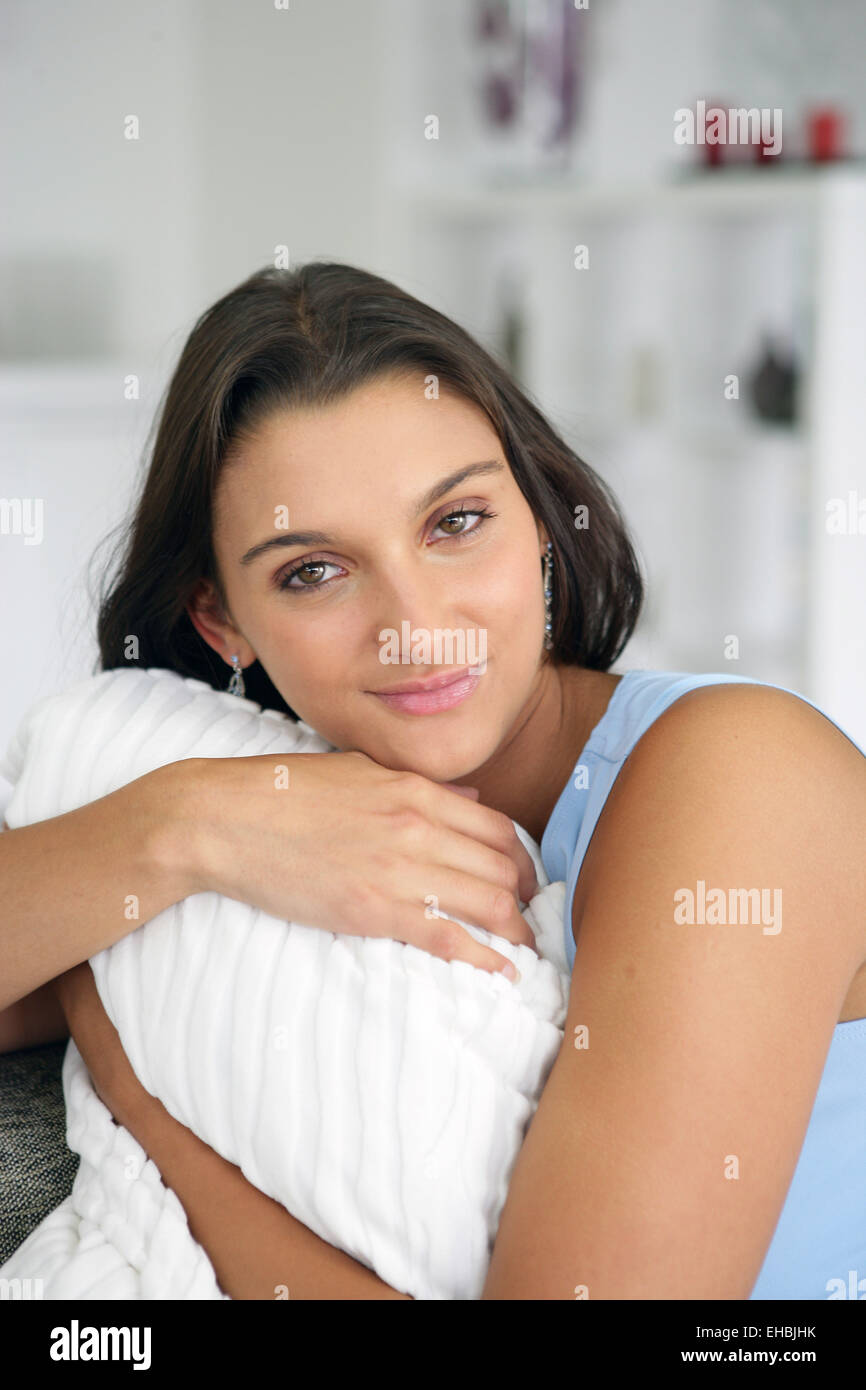 Woman hugging a cushion Stock Photo - Alamy