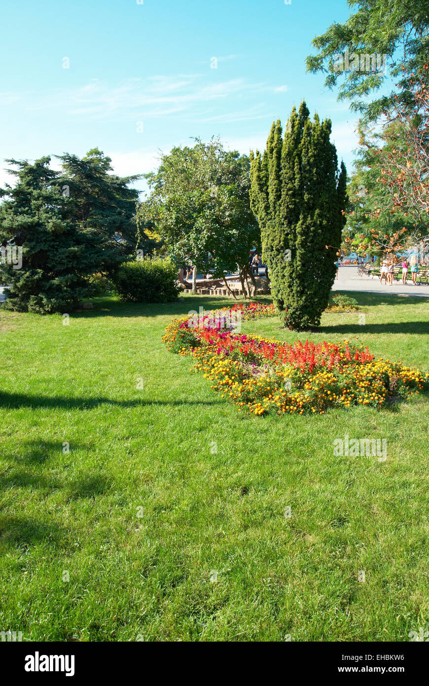 Green sunny park with flowers and trees Stock Photo - Alamy