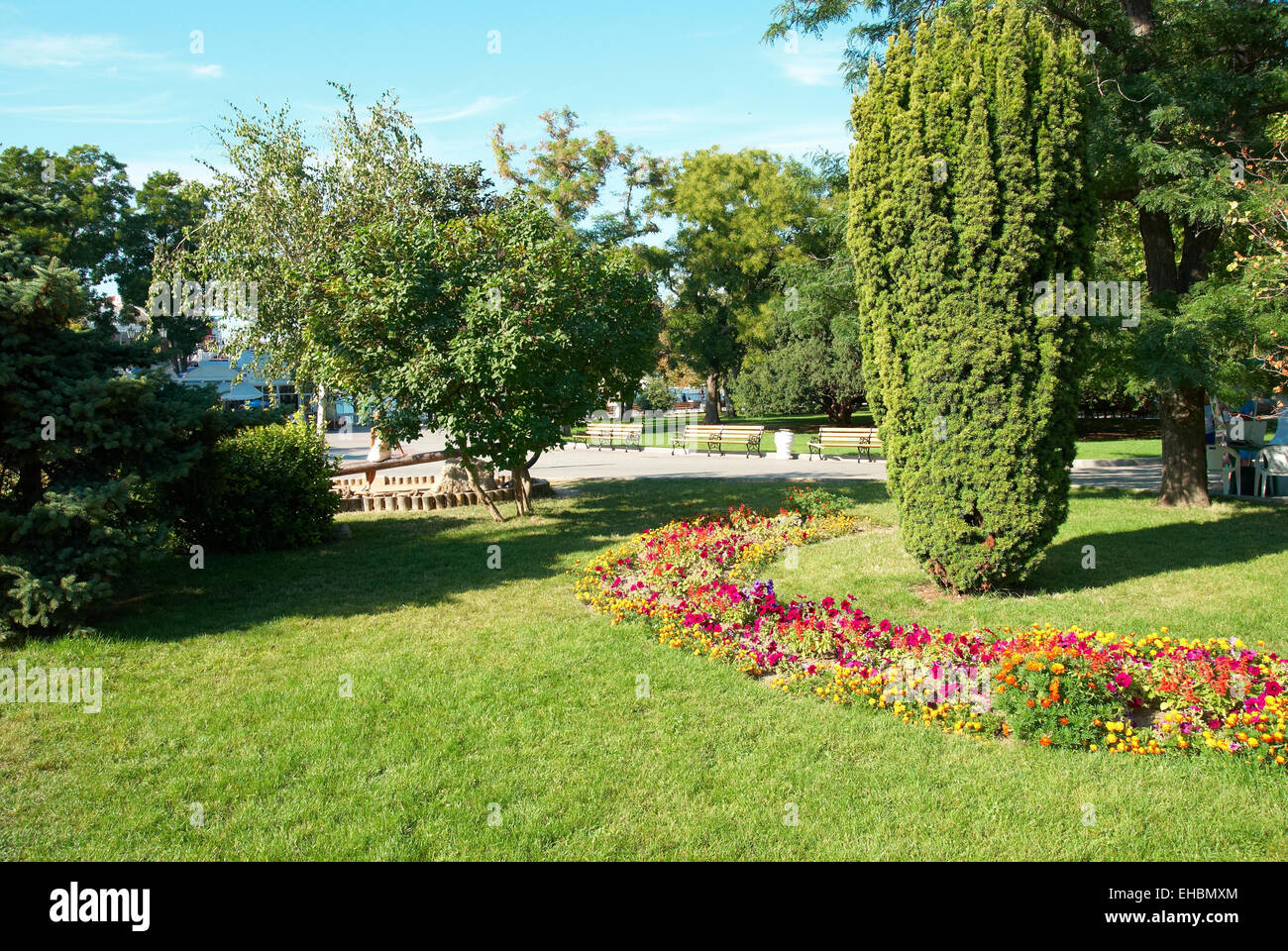Green sunny park with flowers and trees Stock Photo - Alamy