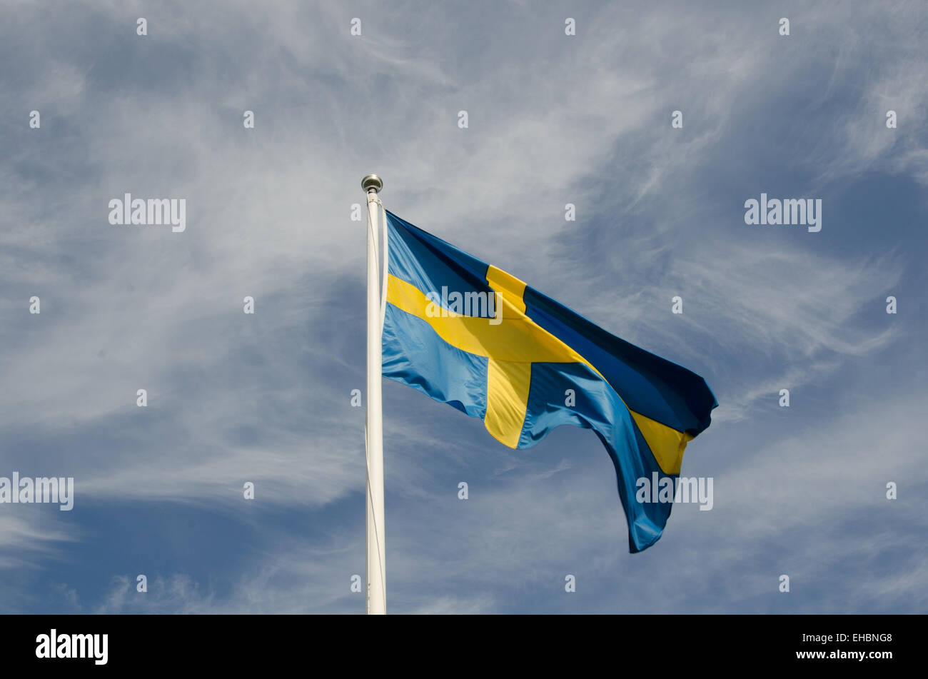 the swedish flag against a blue sky a beutiful summerday Stock Photo ...