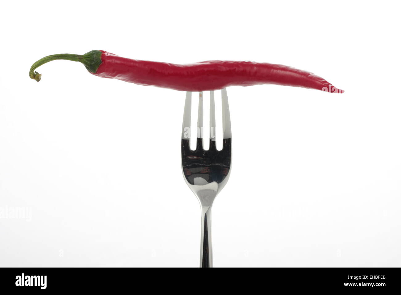 red hot chili pepper on a fork Stock Photo - Alamy