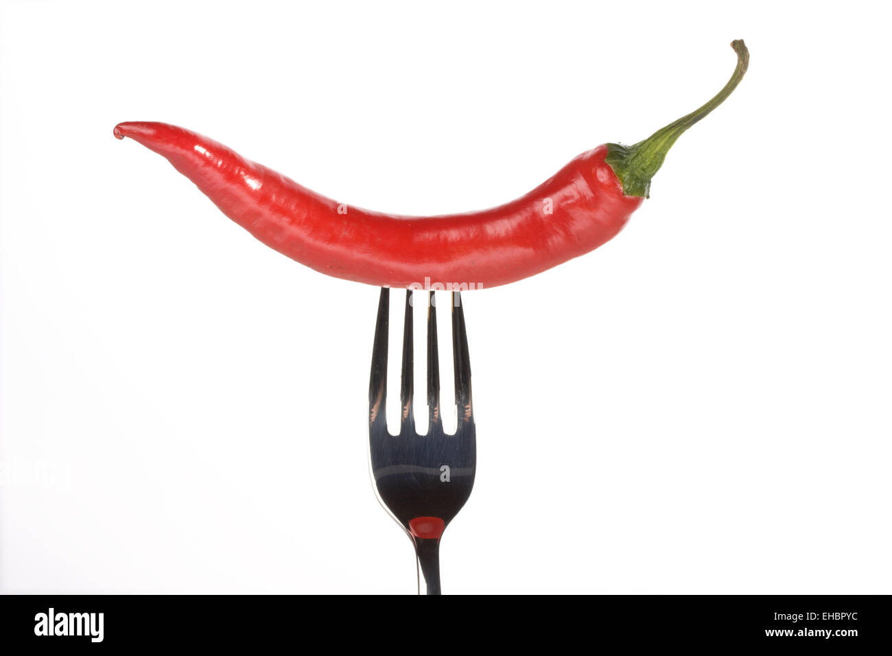 single red hot chili pepper on a fork Stock Photo - Alamy
