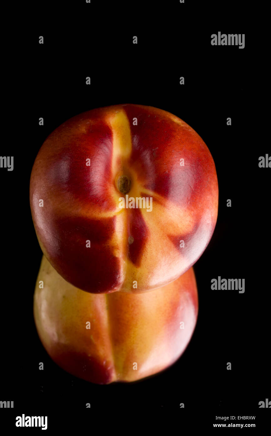 single nectarine on a mirror Stock Photo - Alamy
