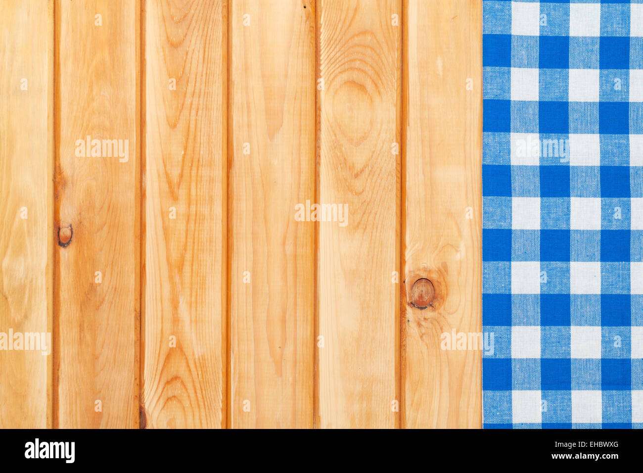 Blue towel over wooden kitchen table. View from above with copy space ...