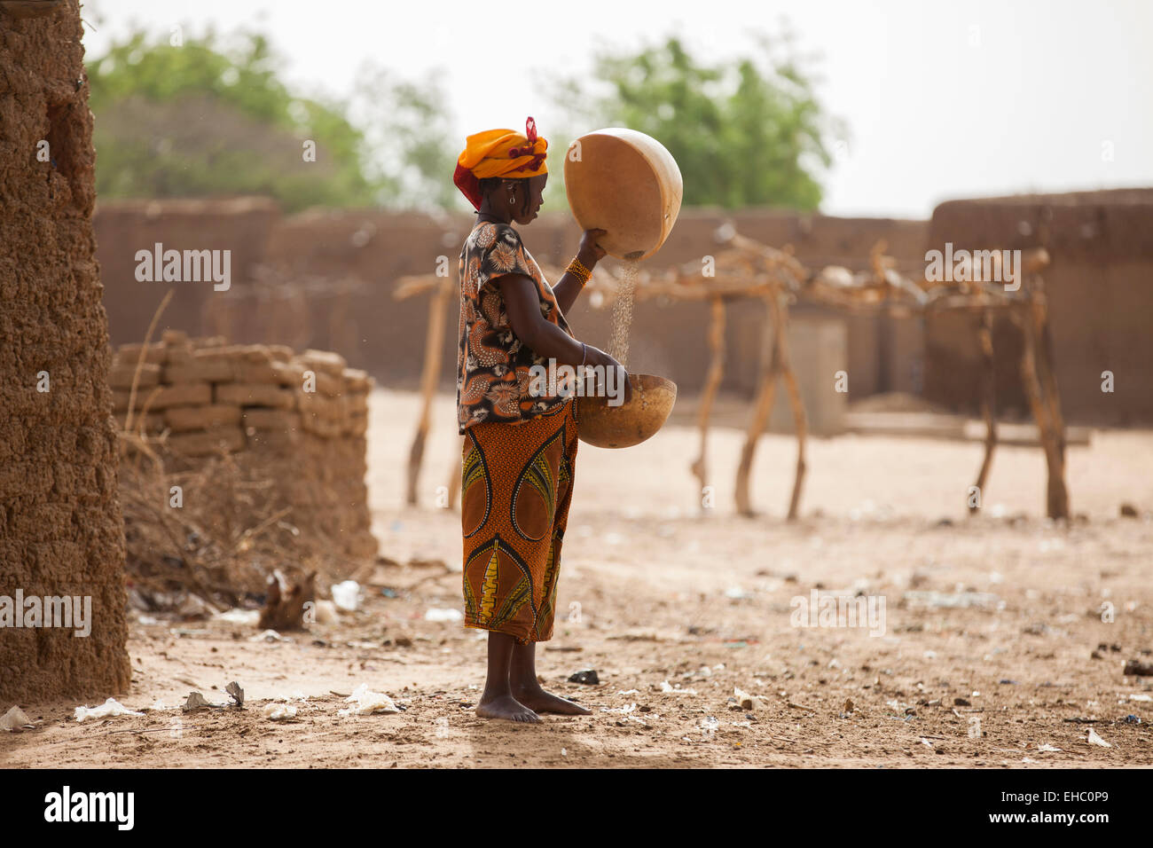 Tera District, west Niger; A young woman winnowing grain before ...