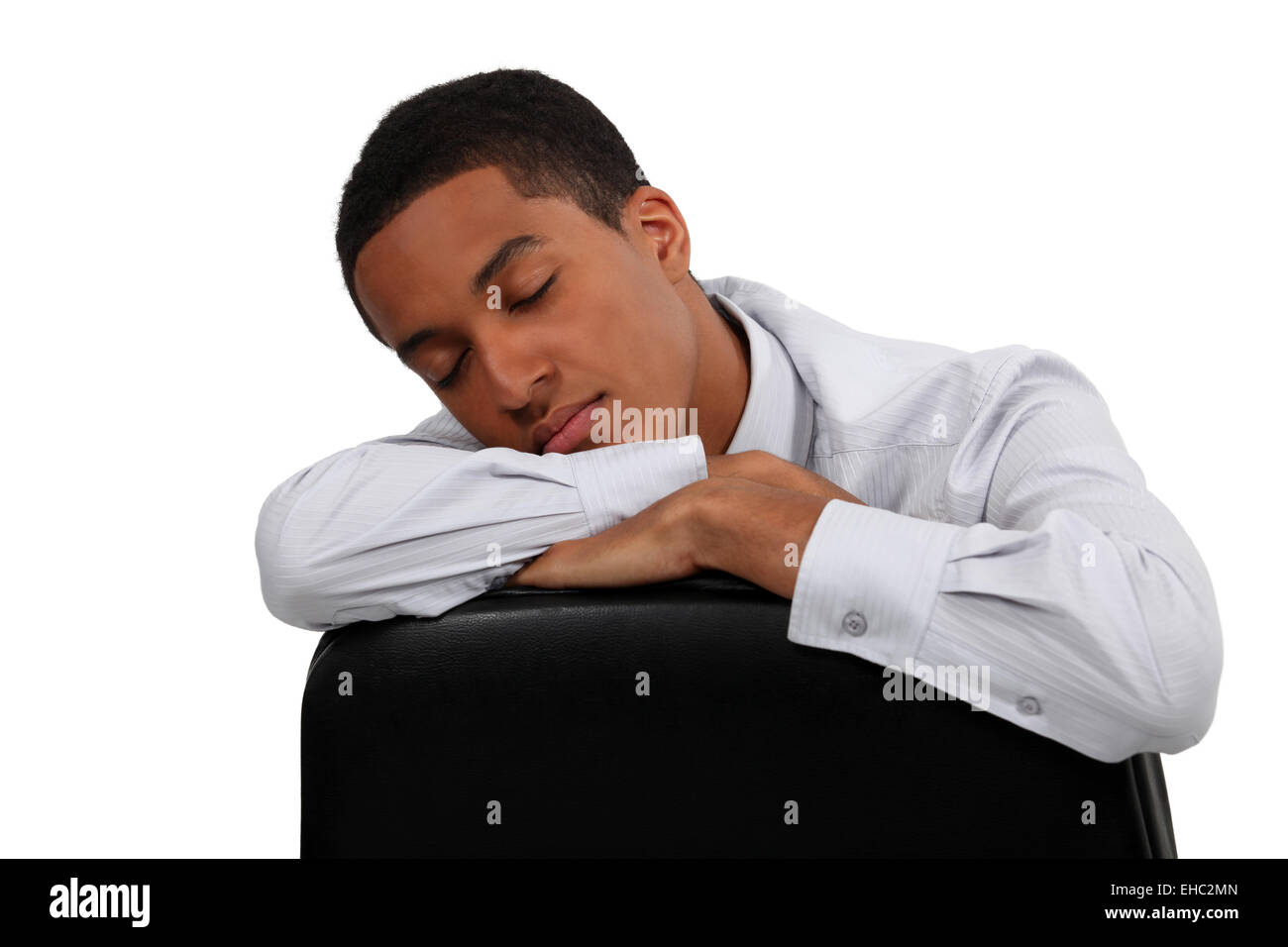 Young man sleeping on the job Stock Photo - Alamy