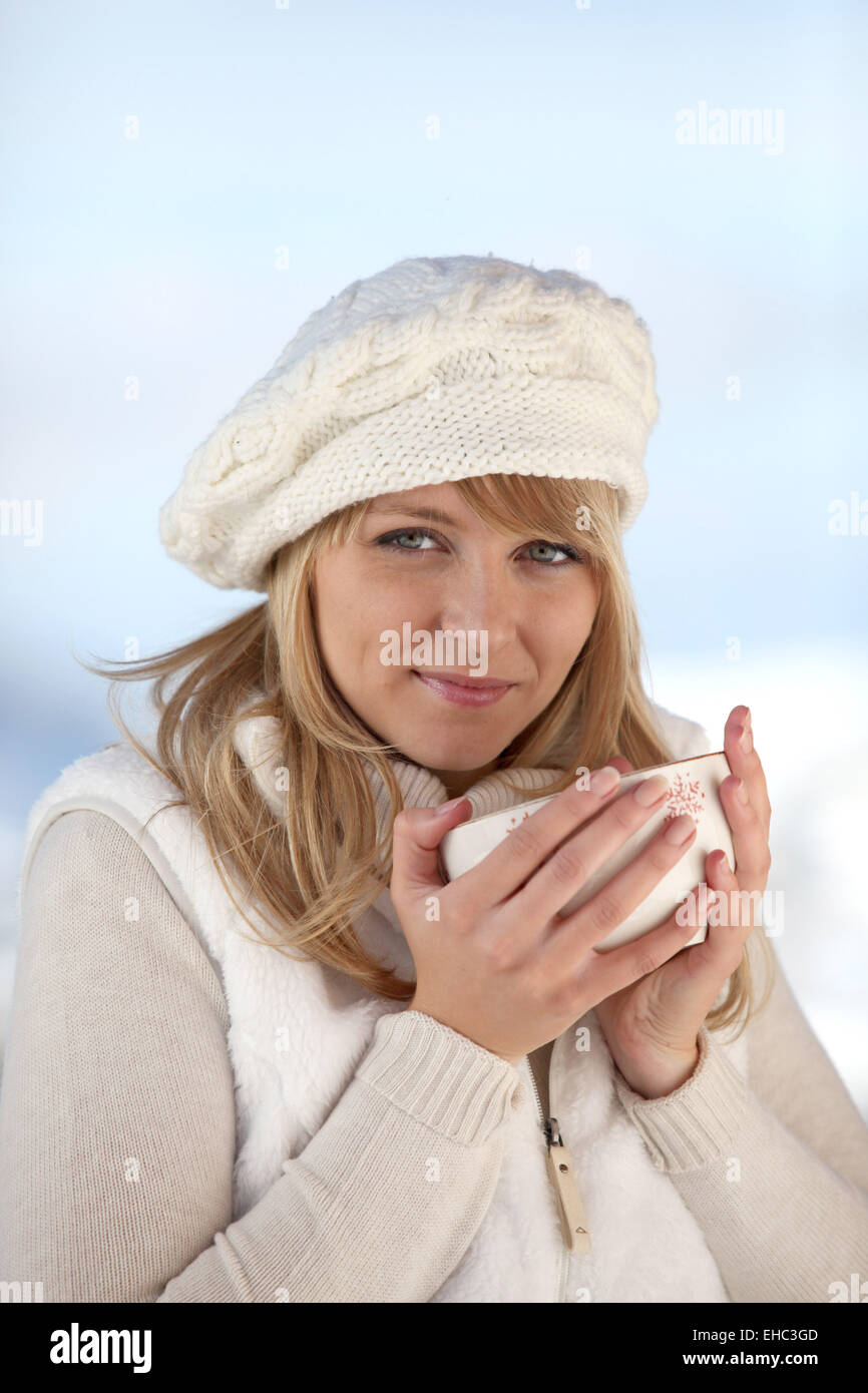 pretty girl drinking tea by wintry day Stock Photo - Alamy