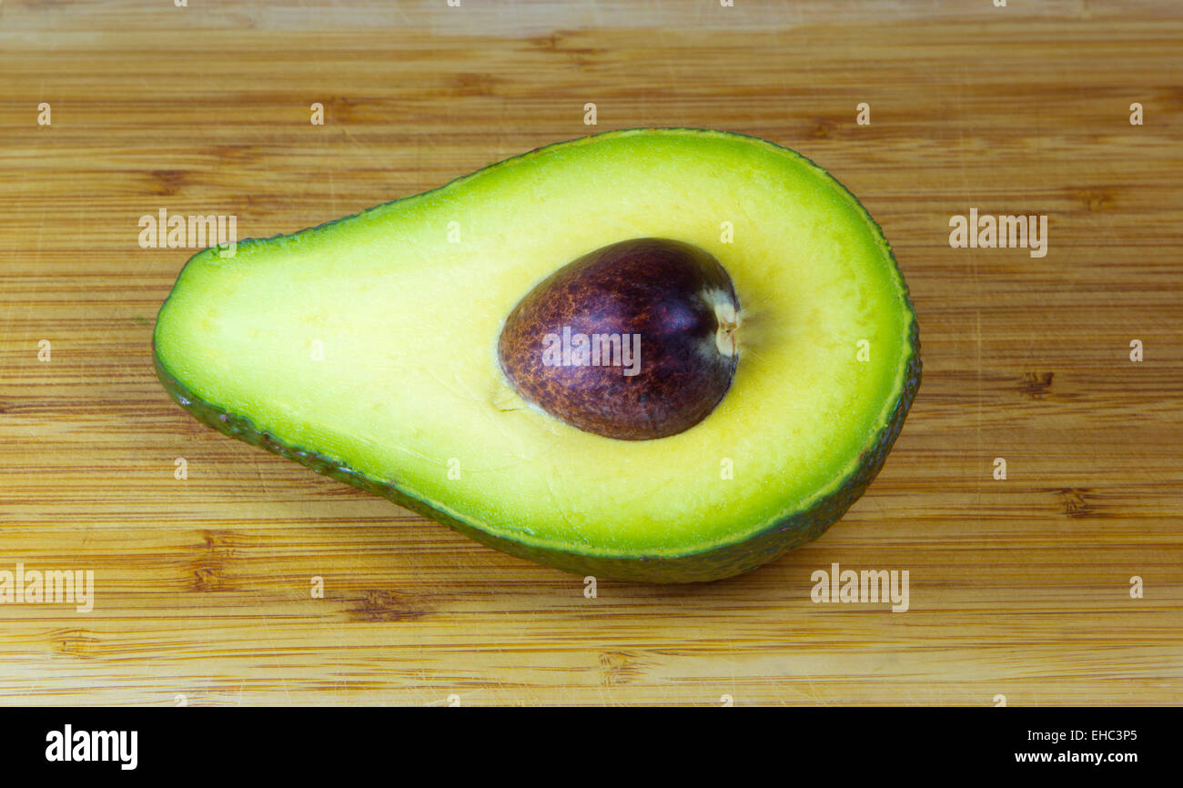 A fresh avocado cut in half Stock Photo - Alamy