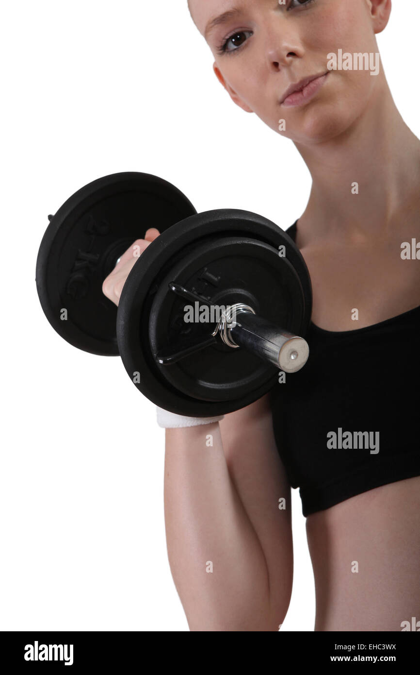 a young woman lifting a dumbbell Stock Photo - Alamy
