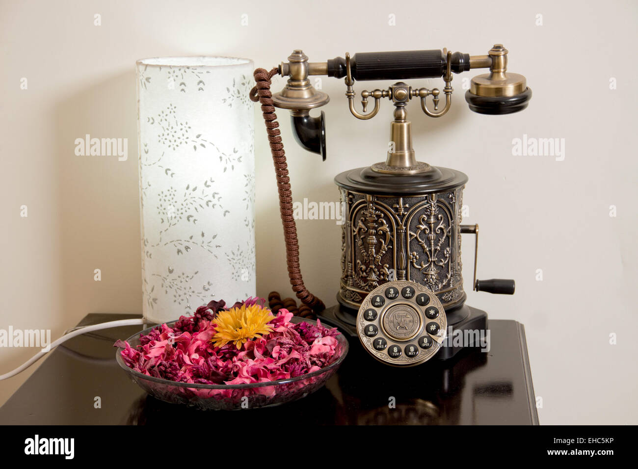 A Vintage Telephone on table with flowers and table lamp Stock Photo ...