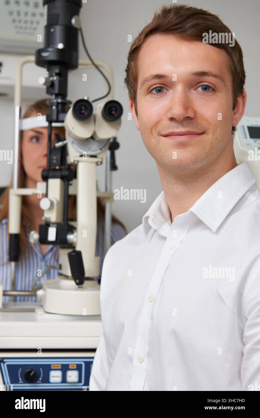 Male Optician Giving Female Patient Eye Examination Stock Photo - Alamy