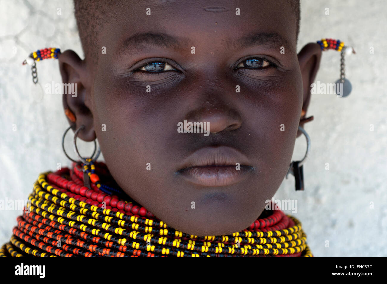 Turkana girl with massive colorful beaded necklaces and pierced ears ...