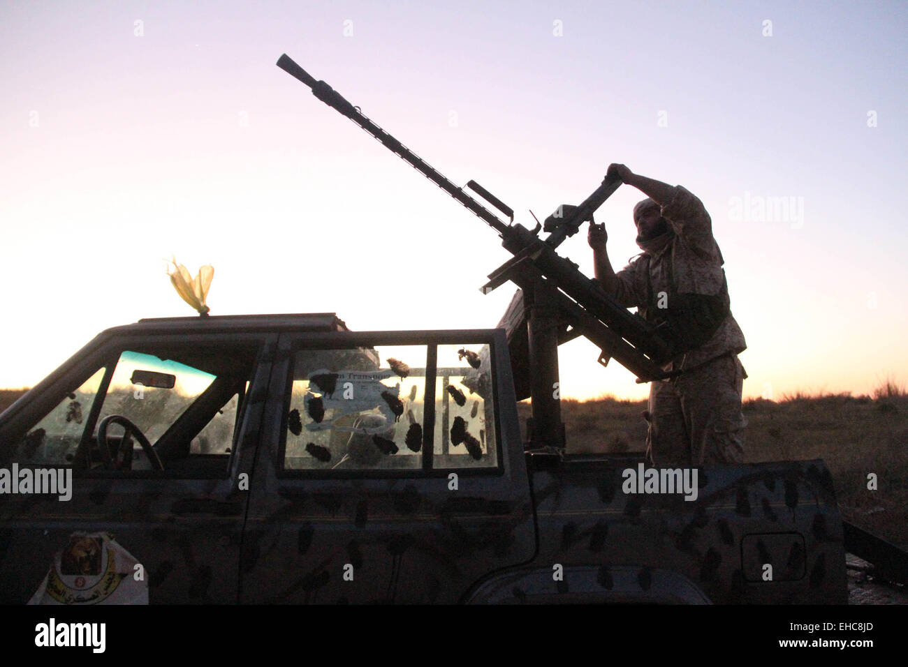 Tripoli. 11th Mar, 2015. A Libya Dawn fighter reloads a machine gun ...