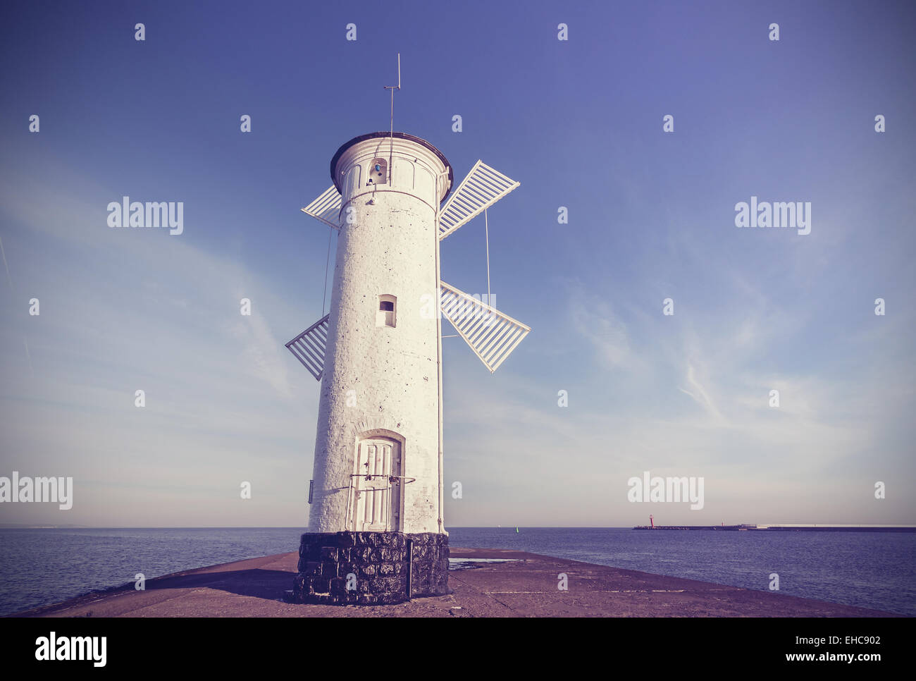 Retro vintage style photo of an old windmill lighthouse in Swinoujscie ...