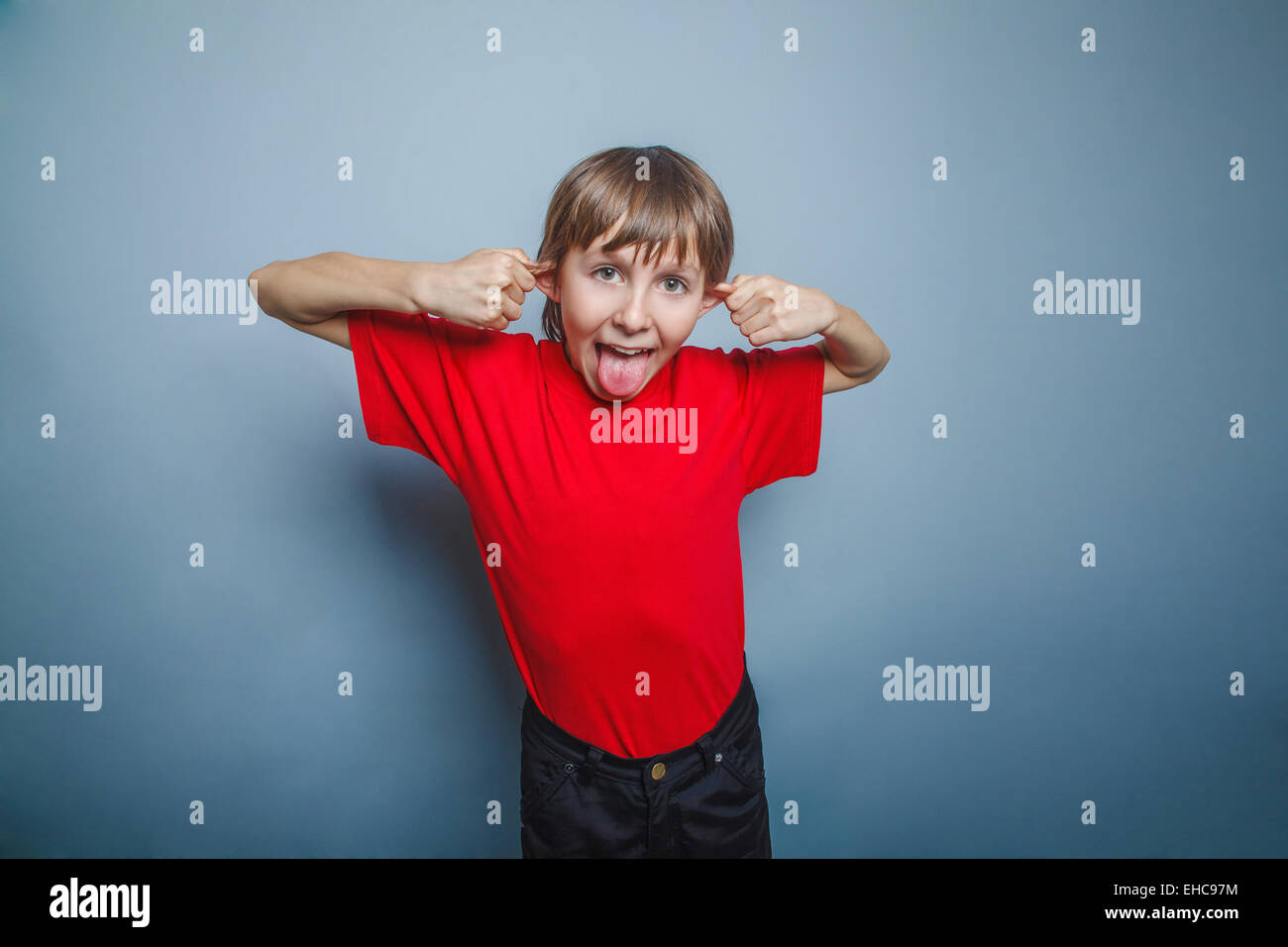 Boy, teenager, twelve years in the red shirt, pulled ears Stock Photo ...