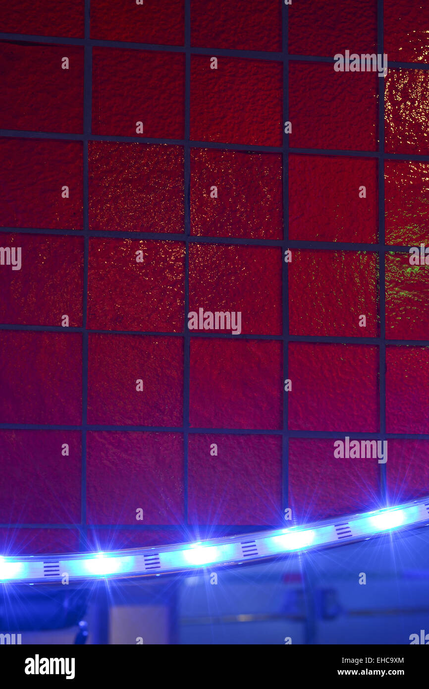 Red wall and blue light Stock Photo - Alamy