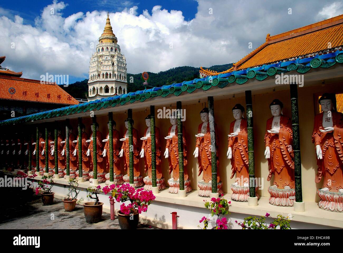 Penang, Malaysia: Row of Buddha statues lines a courtyard arcade and ...