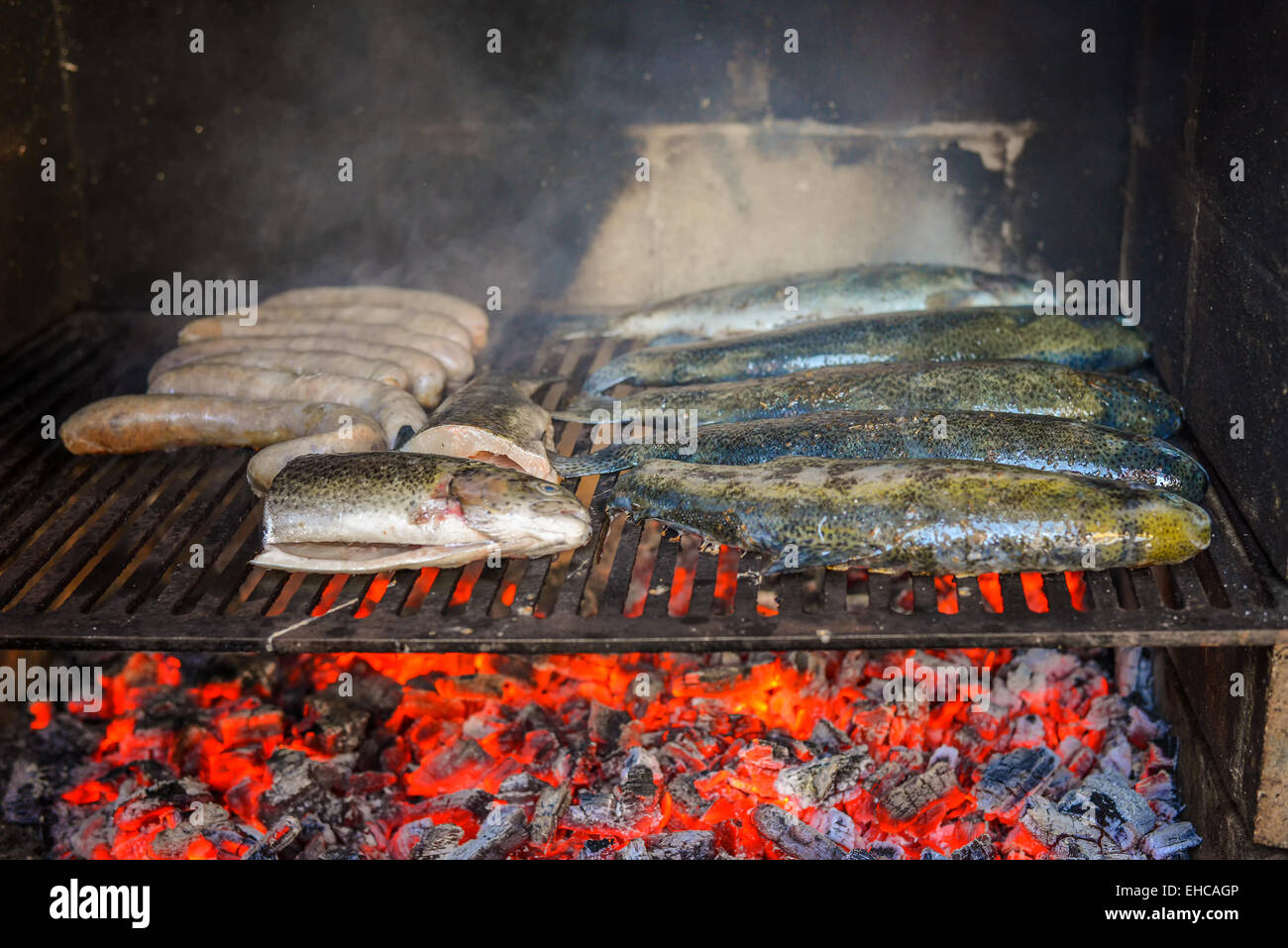 Fish seated on brick barbecue fried in natural light Stock Photo - Alamy