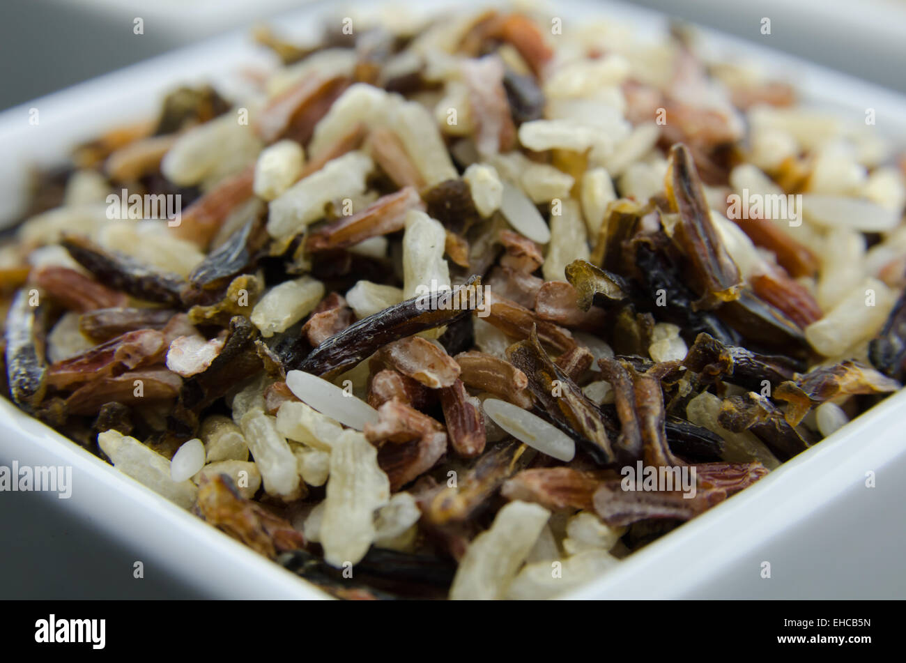 A close up of wild rice grains in a white ceramic bowl Stock Photo - Alamy