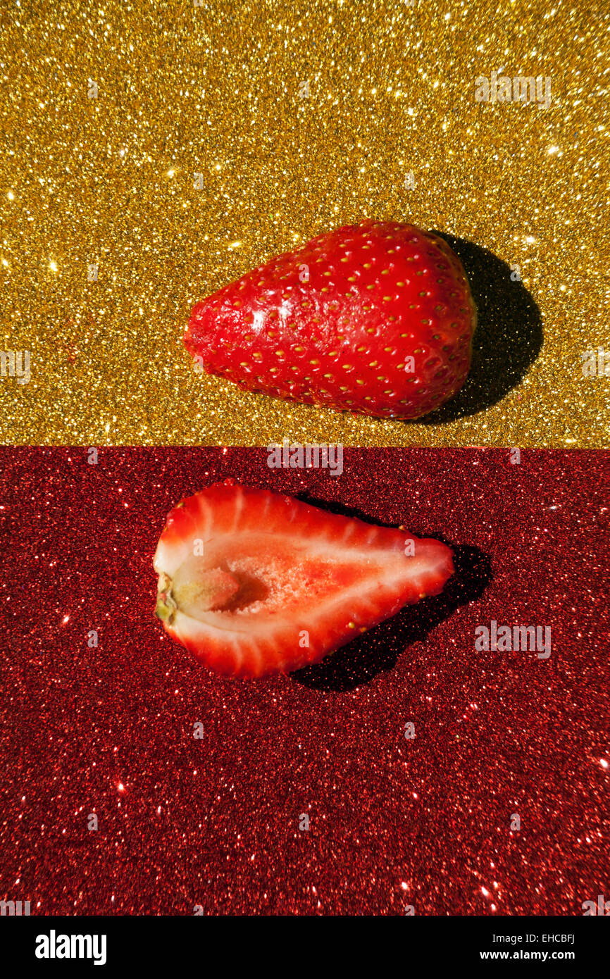 Two slices of a strawberry, gold and red, a very glittery image Stock ...
