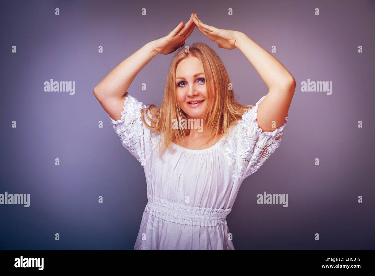 European-looking woman thirty years his hands over his head, a g Stock ...