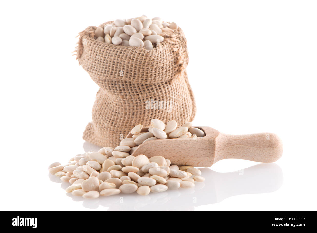 White beans bag with wooden scoop on white background Stock Photo - Alamy