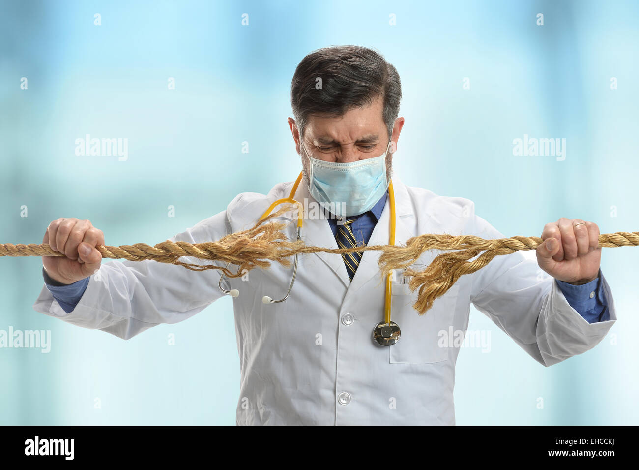 Doctor holding frayed rope inside hospital building Stock Photo - Alamy