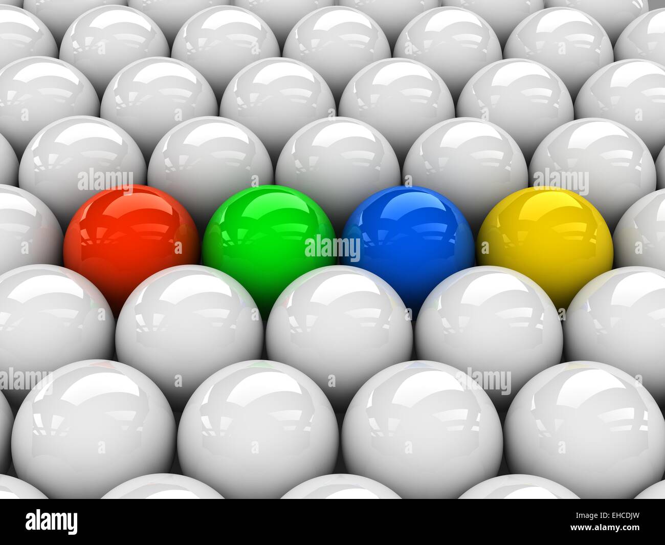 four colorful spheres placed observably in a group of white spheres ...