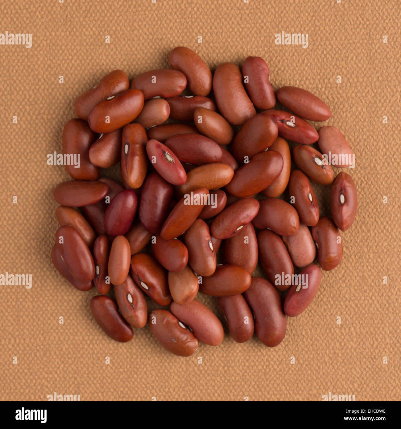 Circle of red beans on brown vinyl background Stock Photo - Alamy