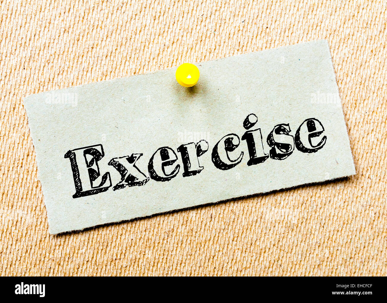 Recycled paper note pinned on cork board. Exercise Message. Concept ...