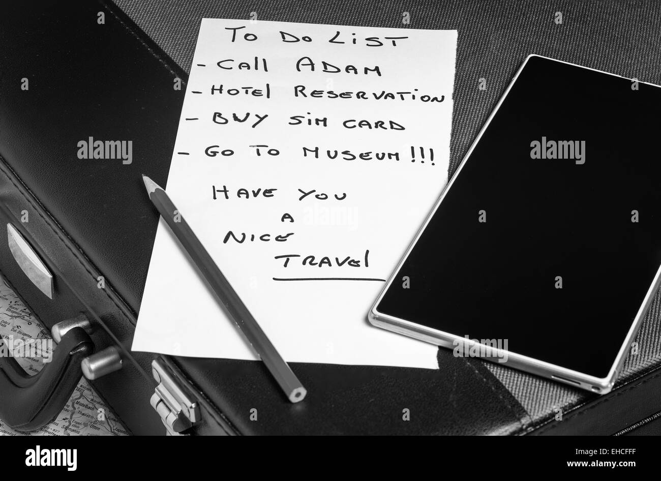 In the pictured a briefcase, map, pencil , a phone / tablet and a list ...