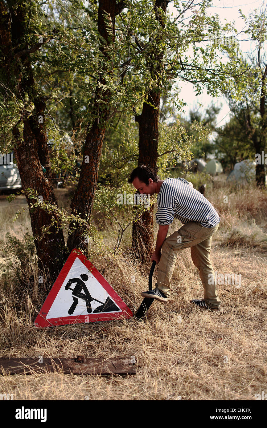 man digging near the sign "forbidden to dig Stock Photo - Alamy