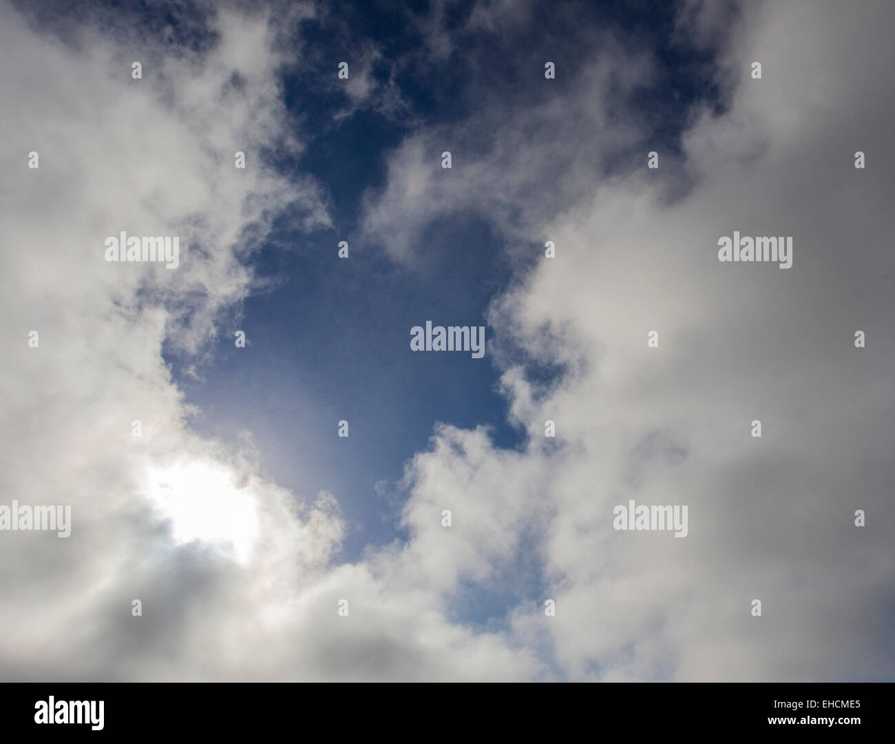 Sun bursting through clouds Stock Photo - Alamy