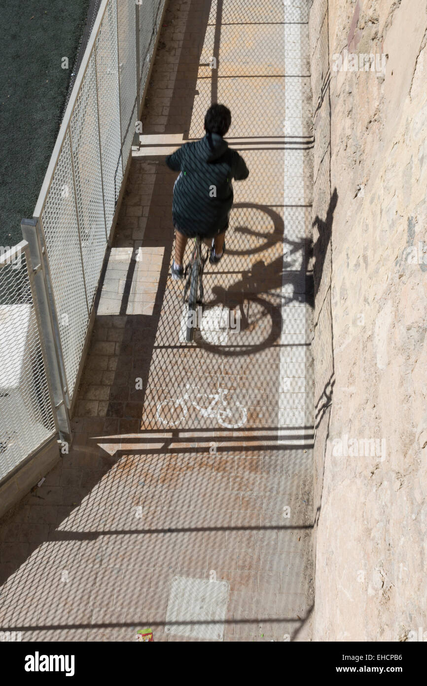Man riding bicycle under the sun Stock Photo - Alamy