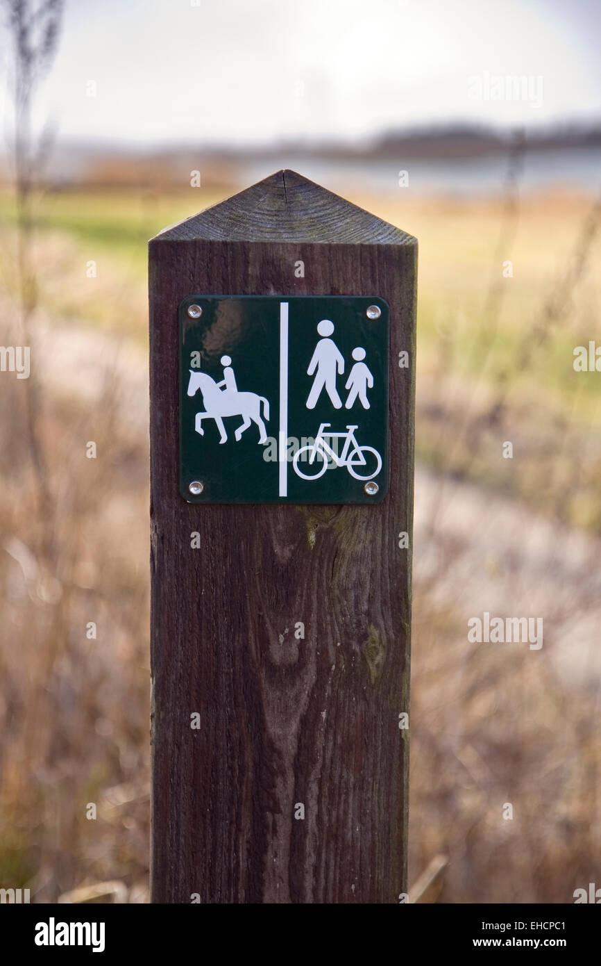 Post with sign showing horseman, pedestrians and bicycle Stock Photo ...