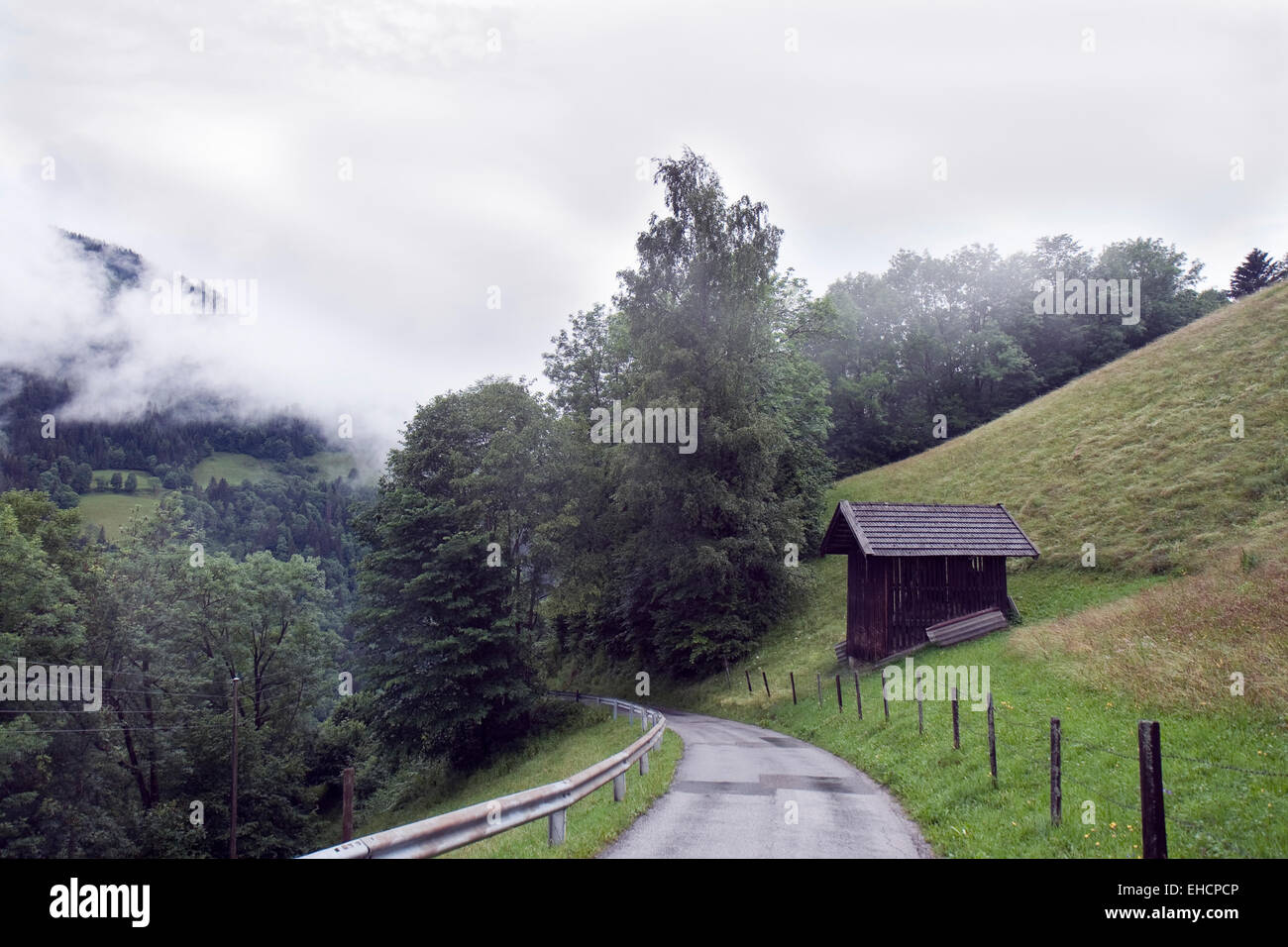 Shack at a mountain road in Austria on a foggy day Stock Photo - Alamy