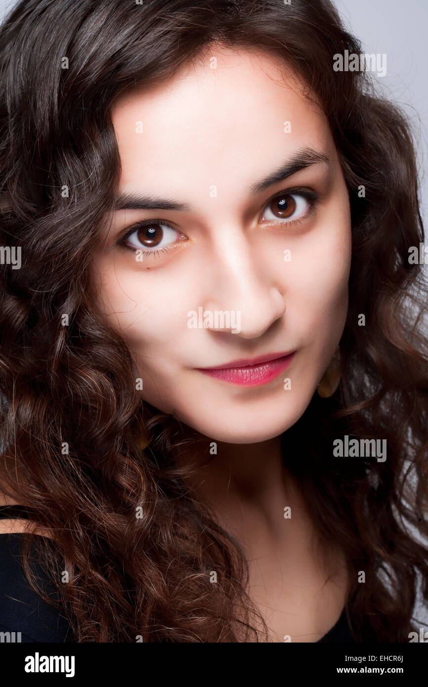 Portrait Of A Young Beautiful Woman With Long Brown Hair And Brown Eyes