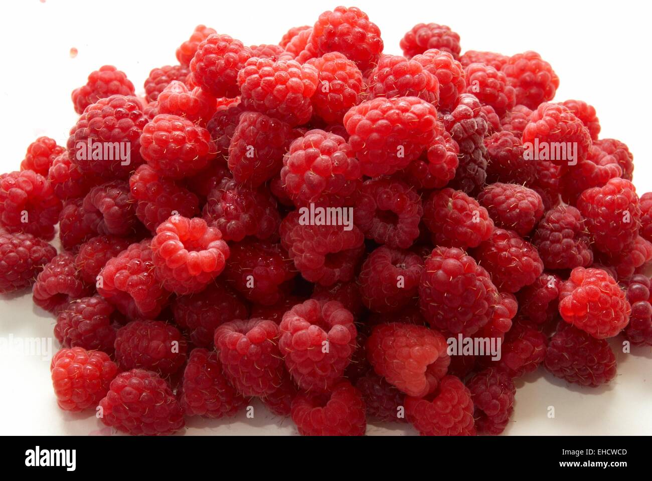 Pile of raspberries isolated on white background Stock Photo - Alamy