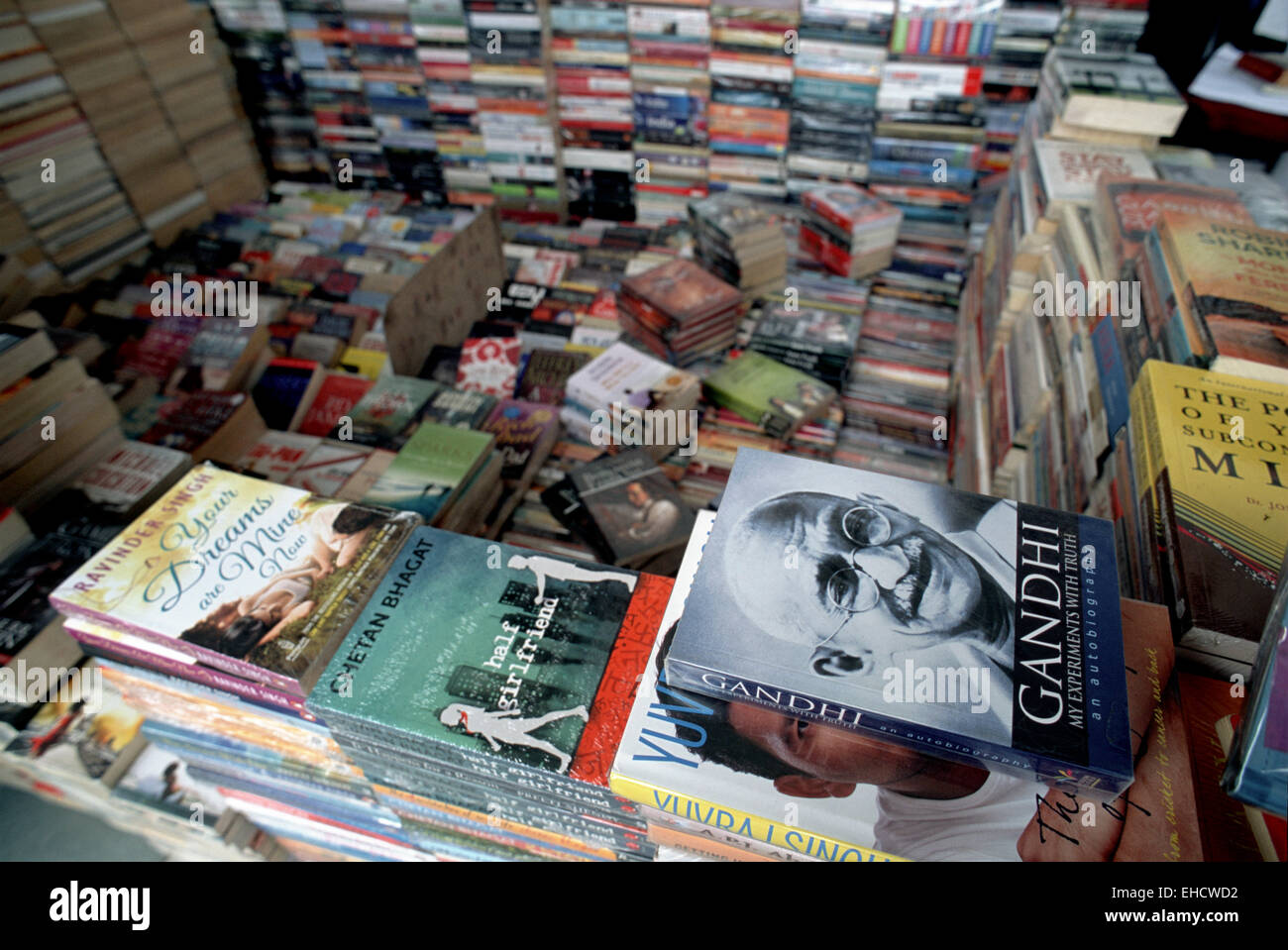 New Delhi India, street seller bookshop, pile of books with Gandhi ...