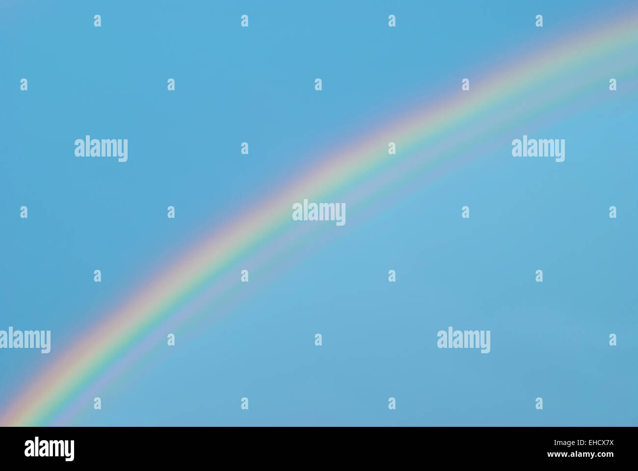 Beautiful colorful rainbow in the blue sky Stock Photo - Alamy