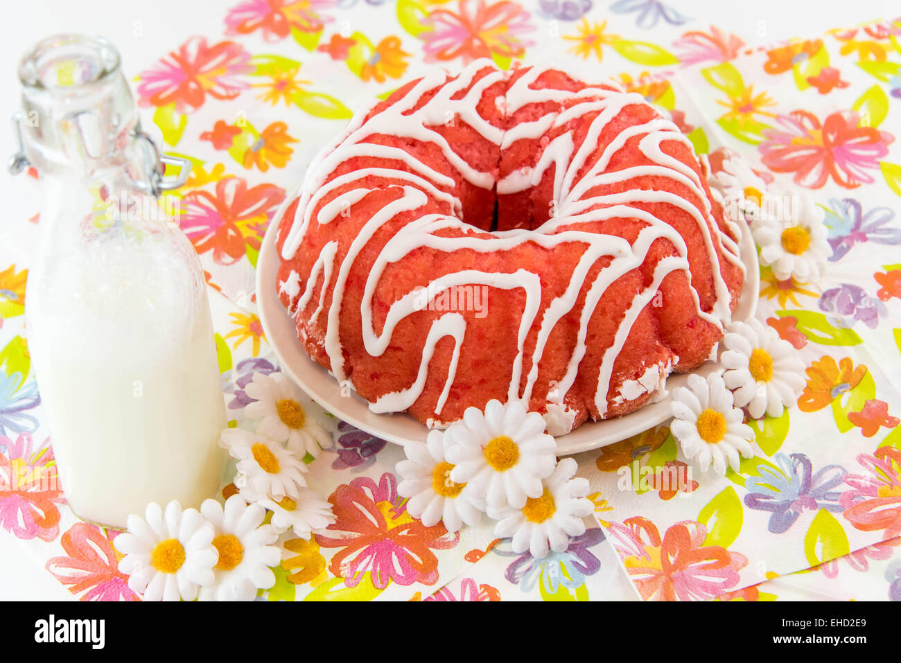 pink cherry pudding cake and a jug of milk Stock Photo - Alamy