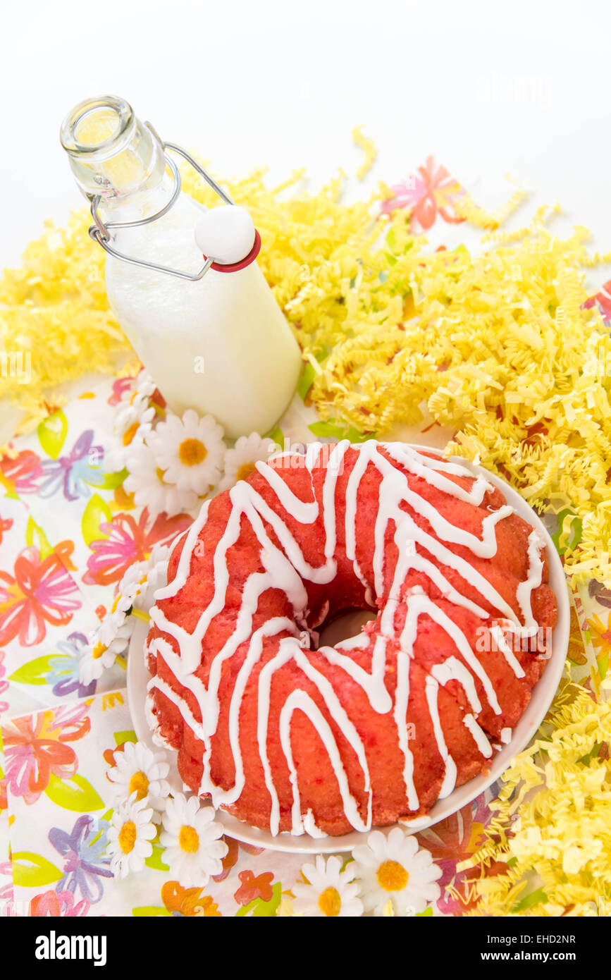 pink cherry pudding cake and a jug of milk Stock Photo - Alamy