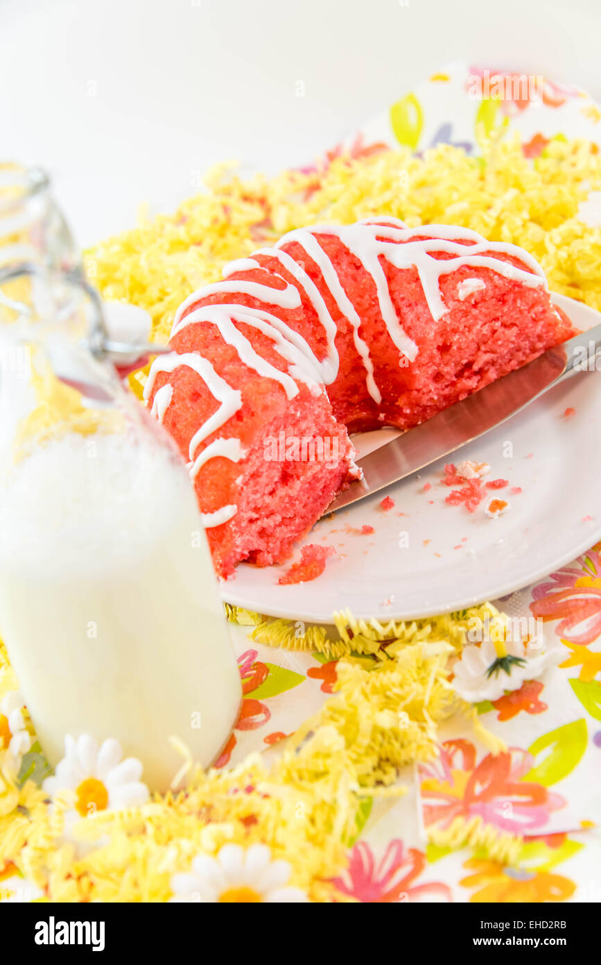 pink cherry pudding cake and a jug of milk Stock Photo - Alamy